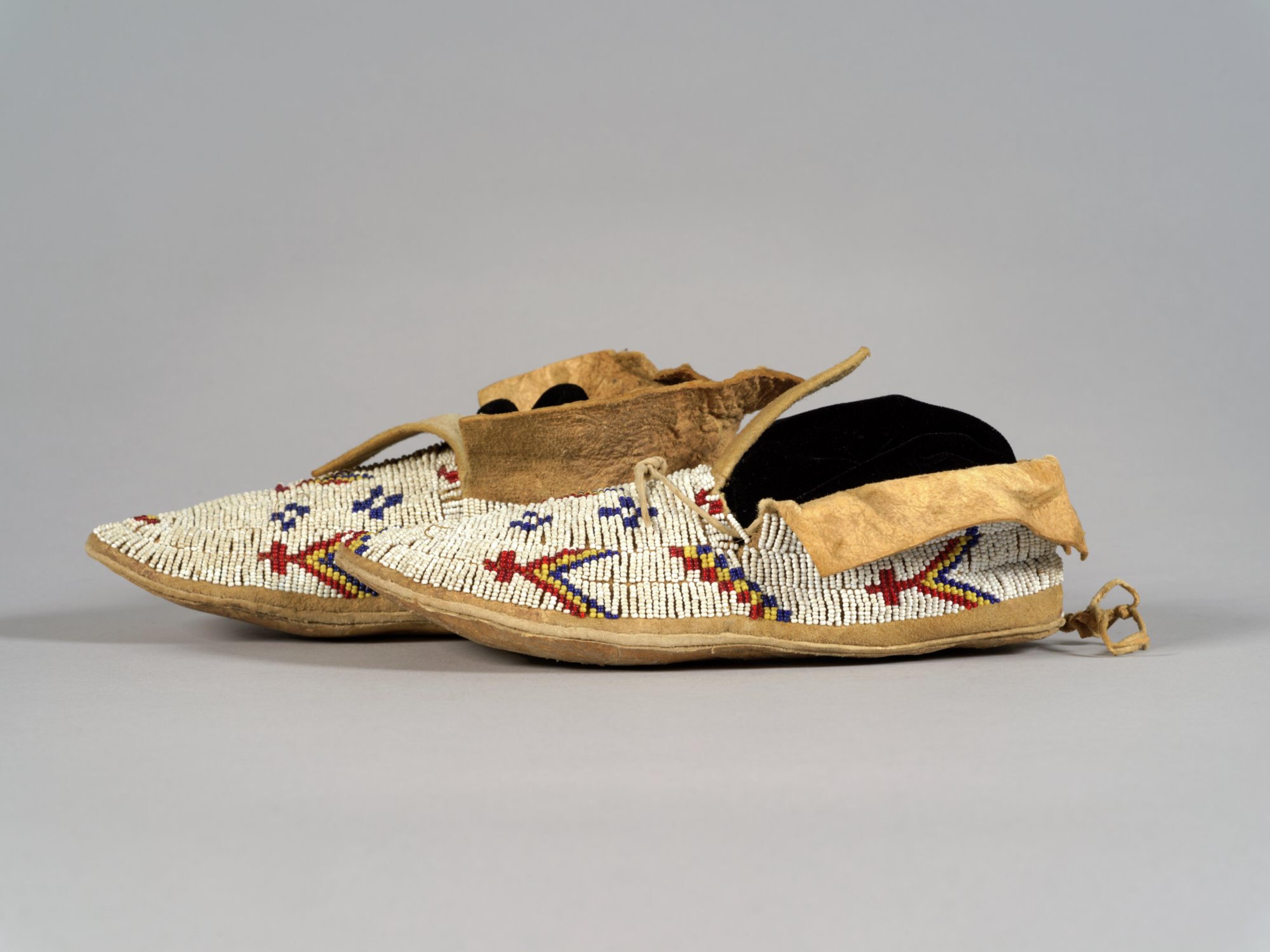Woman’s beaded leather moccasins with white beaded field and various ...