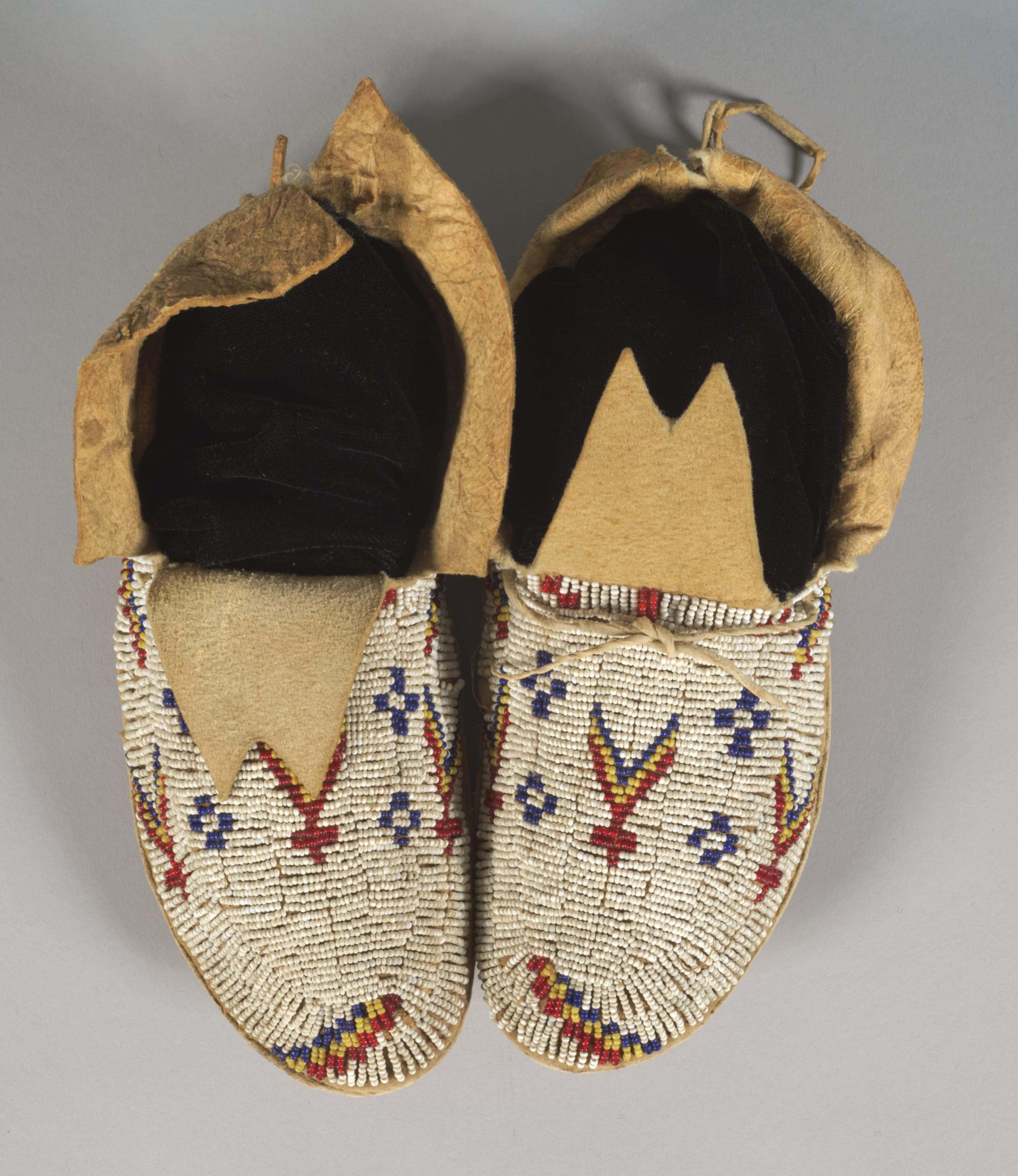 Woman’s beaded leather moccasins with white beaded field and various ...