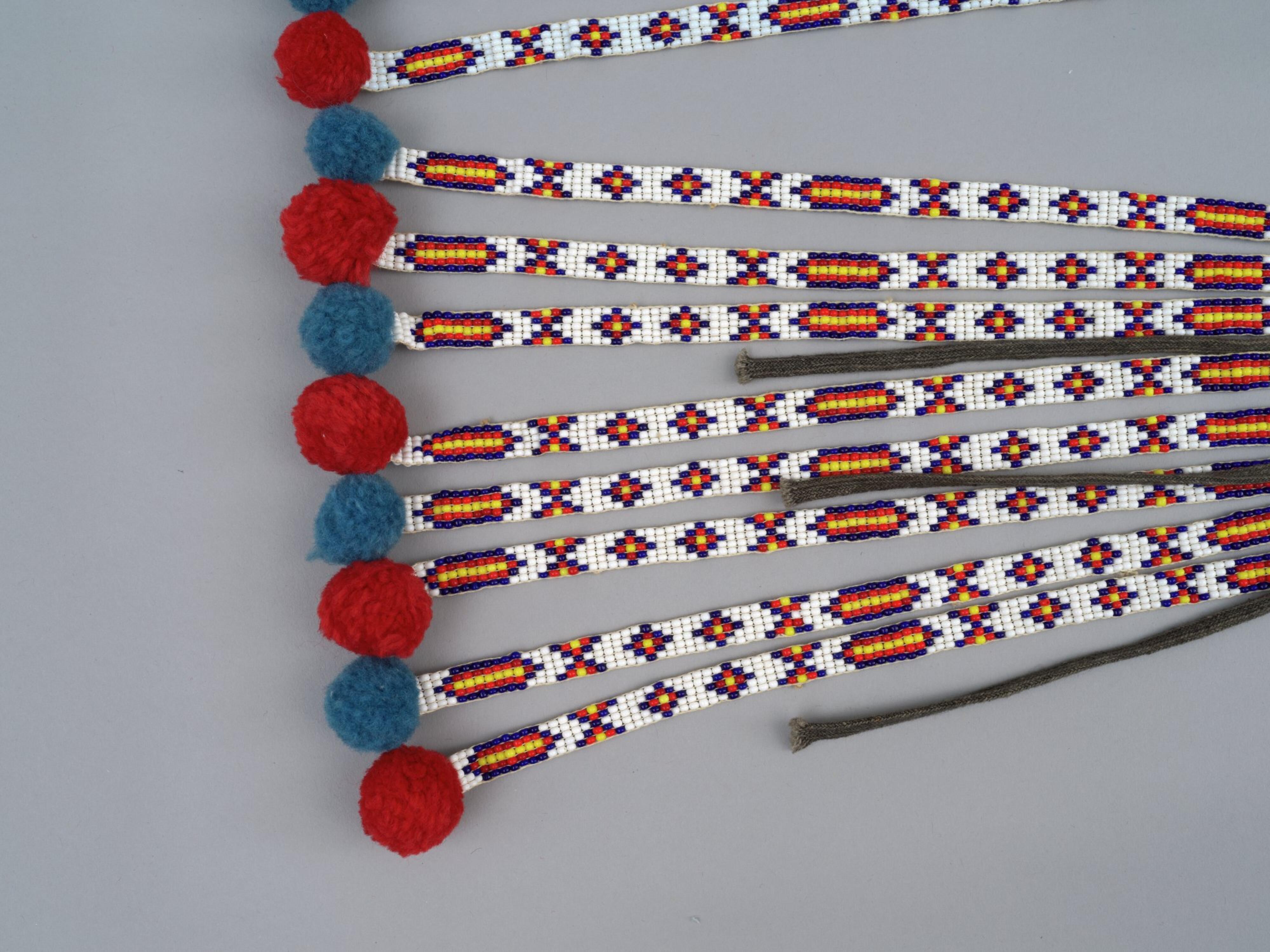 Beaded arm bands with geometric design in black, red, yellow, blue and ...